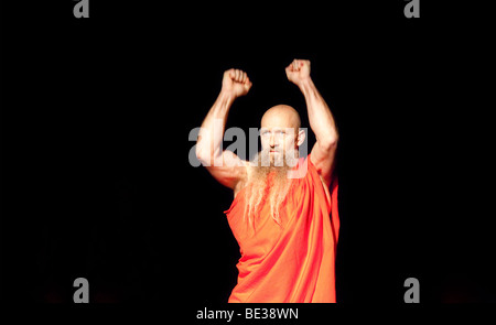 Kung Fu fighter with a long beard dressed as a monk on a theater stage ...