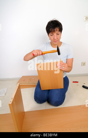 New case. Dark-haired female doctor sitting on the floor and ...