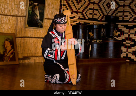An Ainu woman plays a traditional stringed instrument - the Mukkur - at ...