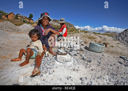 Child labourers work in a quarry breaking stones to build roads. Takeo ...