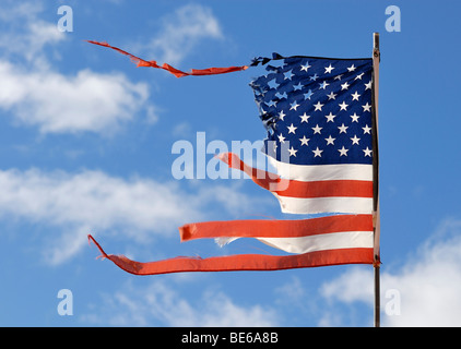 Torn USA Flag, Stars & Stripes, on a flagpole with a lifebuoy Stock ...