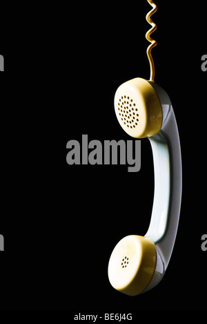telephone receiver hanging off the hook Stock Photo - Alamy