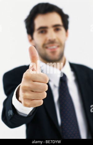 Grinning businessman giving the thumb's up Stock Photo - Alamy
