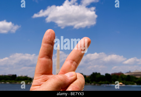 Abstract of man's fingers making victory gesture at Washington Monument ...