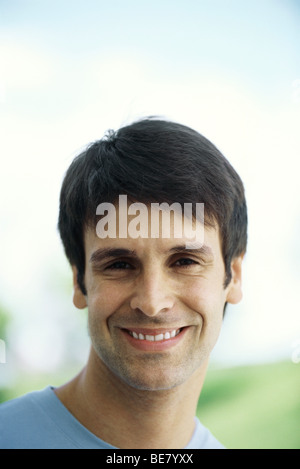 Smiling average age man in blue sweater isolated on white background ...