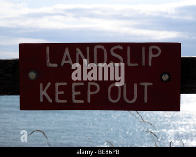 'Landslip, Keep Out' warning sign at edge of cliff, Osmington, Dorset ...