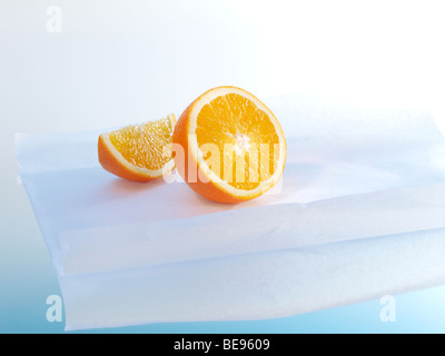 Orange cut into quarters Stock Photo - Alamy