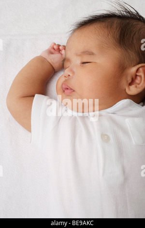 Head shot of a sleeping baby lying in a cot Stock Photo - Alamy
