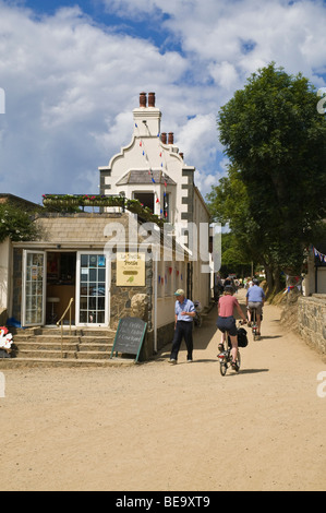 dh SARK VILLAGE SARK ISLAND Cycling tourists village main street ...