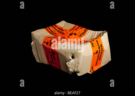 Damaged parcel with fragile tape Stock Photo - Alamy