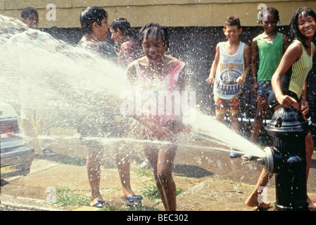 kids playing in fire hydrant sprinkler during Brooklyn block party ...