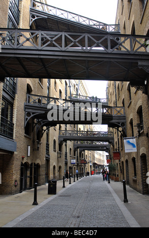 Shad Thames road and wharf bridges behind the old river warehouses ...