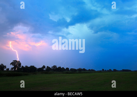 Lightning striking the ground Stock Photo - Alamy
