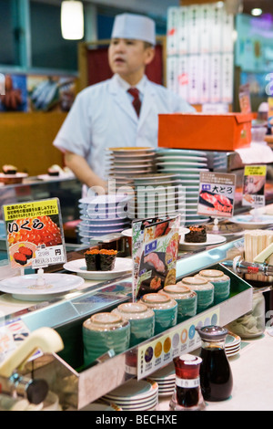 Interior of a typical Japanese conveyor belt sushi restaurant. Close up ...