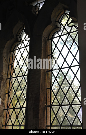 Diamond leaded windows in a church with sunlight and shadows. UK Stock ...