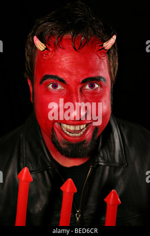 Devilish man with red skin, horns, and maniacal scream Stock Photo - Alamy