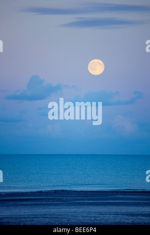 Britain UK. October Full moon in the sky at dusk Stock Photo - Alamy