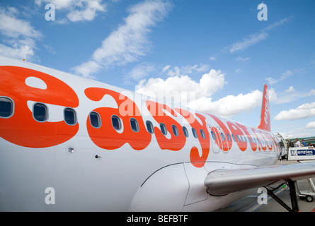 A close up of the EasyJet logo on the tail fin of a passenger aircraft ...