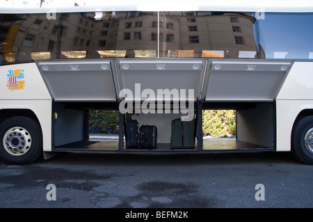 driver Loading luggage into luggage hold of a coach Stock Photo - Alamy