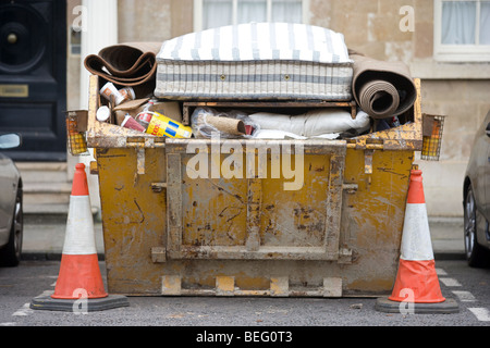 Builders Skip Parked In A Car Parking Space Stock Photo - Alamy