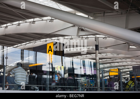 Inside Heathrow airport terminal 5 departures waiting area with seating ...
