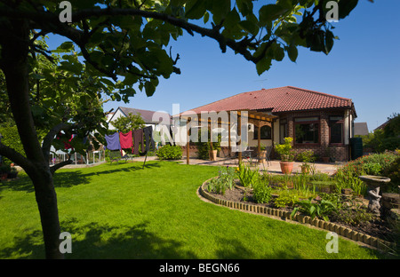 Back garden of bungalow with pergola and patio, England Stock Photo - Alamy