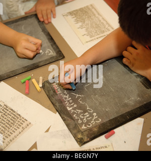 An old fashioned school slate in a bag hanging from a peg in the Stock ...