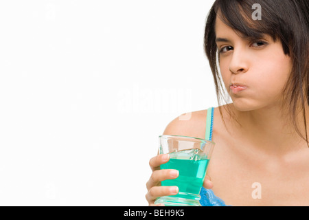 Portrait of a young woman gargling Stock Photo - Alamy
