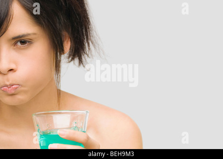 Portrait of a young woman gargling Stock Photo - Alamy