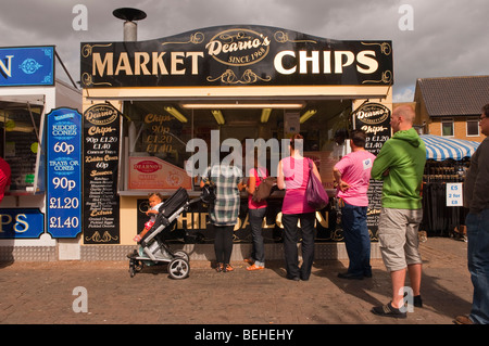 People eating chips from a chip stall at the market in Great Yarmouth ...