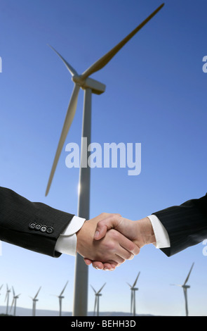 Businessmen shaking hands over blue sky, low angle view Stock Photo - Alamy