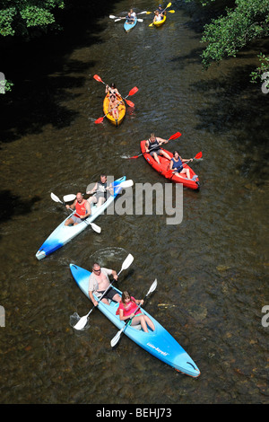 Kayakers / canoers kayaking / canoeing in colourful kayaks / canoes on ...
