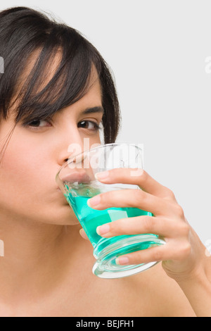 Portrait of a young woman gargling with mouthwash Stock Photo - Alamy
