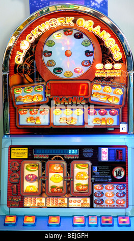 Brightly coloured slot, gaming and fruit machines in amusement arcade ...
