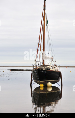 Yacht on beaching legs at low tide, Newport, Pembrokeshire, Wales Stock ...
