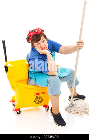 Tired woman with cleaning supplies sitting on floor in kitchen Stock ...