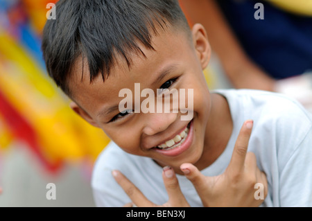 Filipino boy or Philippine children stand and playing beside street at ...