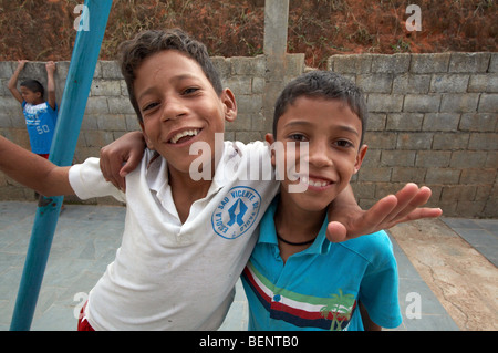 Portrait of a boy with football in a slum (favela) of Recife, Brazil ...