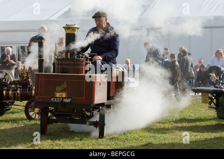 a live steam enthusiast driving his scale model steam lorry with his ...