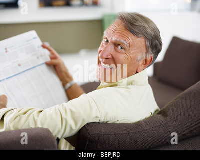 Senior man reading newspaper Stock Photo - Alamy