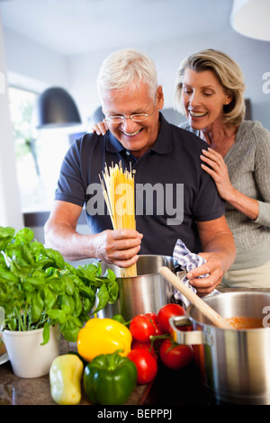 Senior man eating spaghetti at kitchen Stock Photo - Alamy