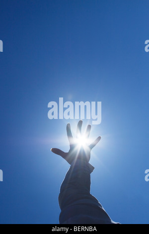 Hand reaching for Sun Stock Photo - Alamy