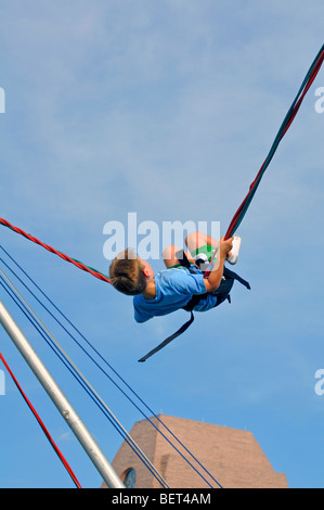 Boy enjoying European bungee Stock Photo - Alamy