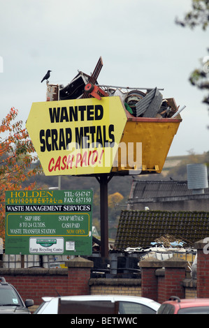 A skip full of scrap metal held aloft to advertise a scrap metal yard ...