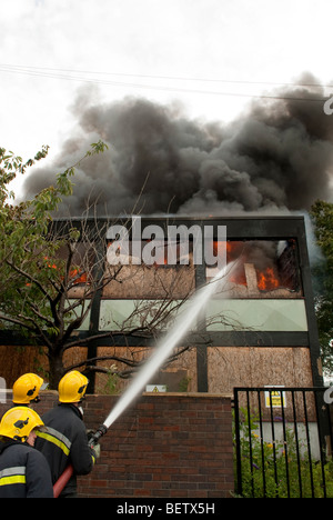 Factory office block on fire with flames and smoke from windows Stock ...