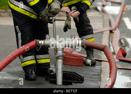 Fire Hydrant stand pipe with dividing branch and hose Stock Photo - Alamy