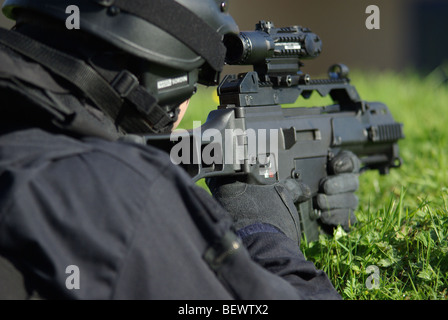 Police firearms officer in containment position Stock Photo - Alamy