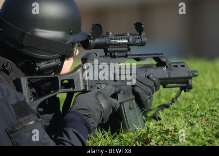 Police firearms officer in containment position Stock Photo - Alamy