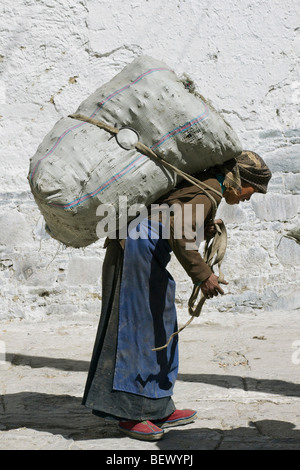 An old lady with a huge weight to carry Stock Photo - Alamy