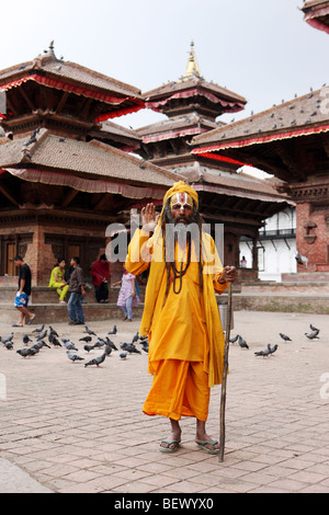 A Sadhu poses with raised hand in blessing at Kathmandu Durbar Square ...
